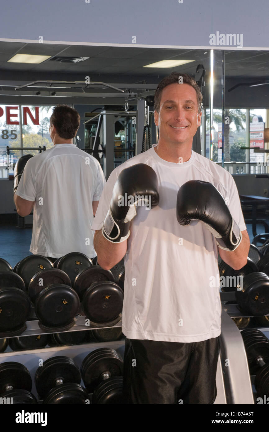 Middle-aged man with boxing gloves at gym Stock Photo - Alamy
