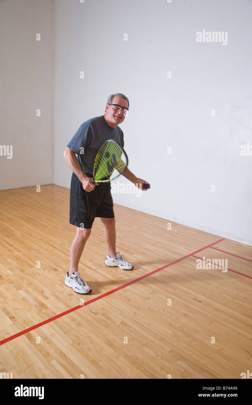 Senior man playing racketball at indoor court Stock Photo - Alamy