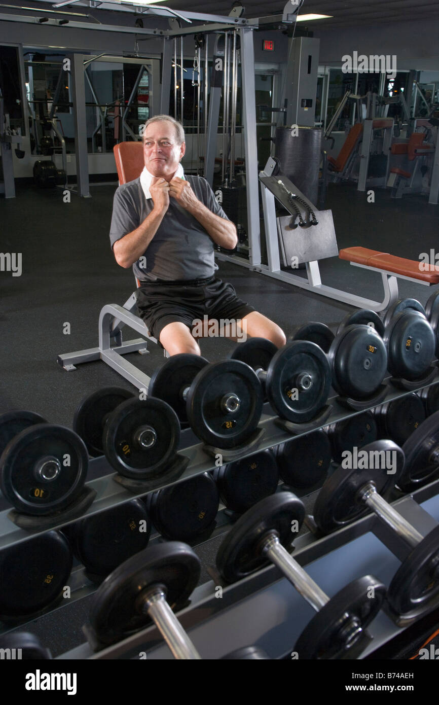 Portrait of senior man working out at gym, seating on bench Stock Photo ...