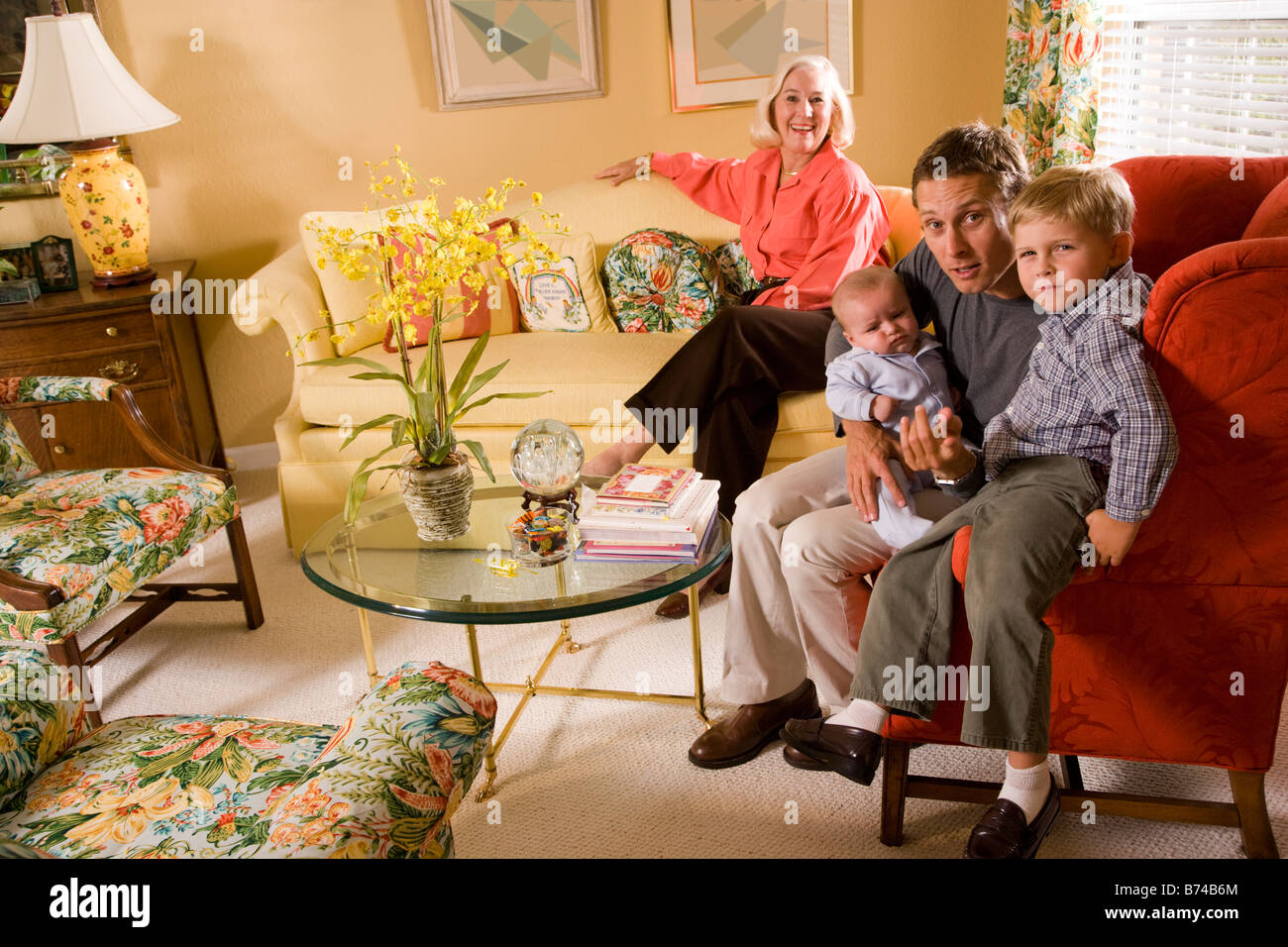 Extended family sitting in living room Stock Photo - Alamy