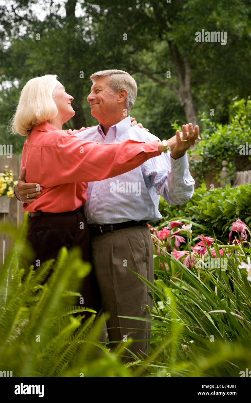 Side view of senior couple dancing in garden Stock Photo - Alamy