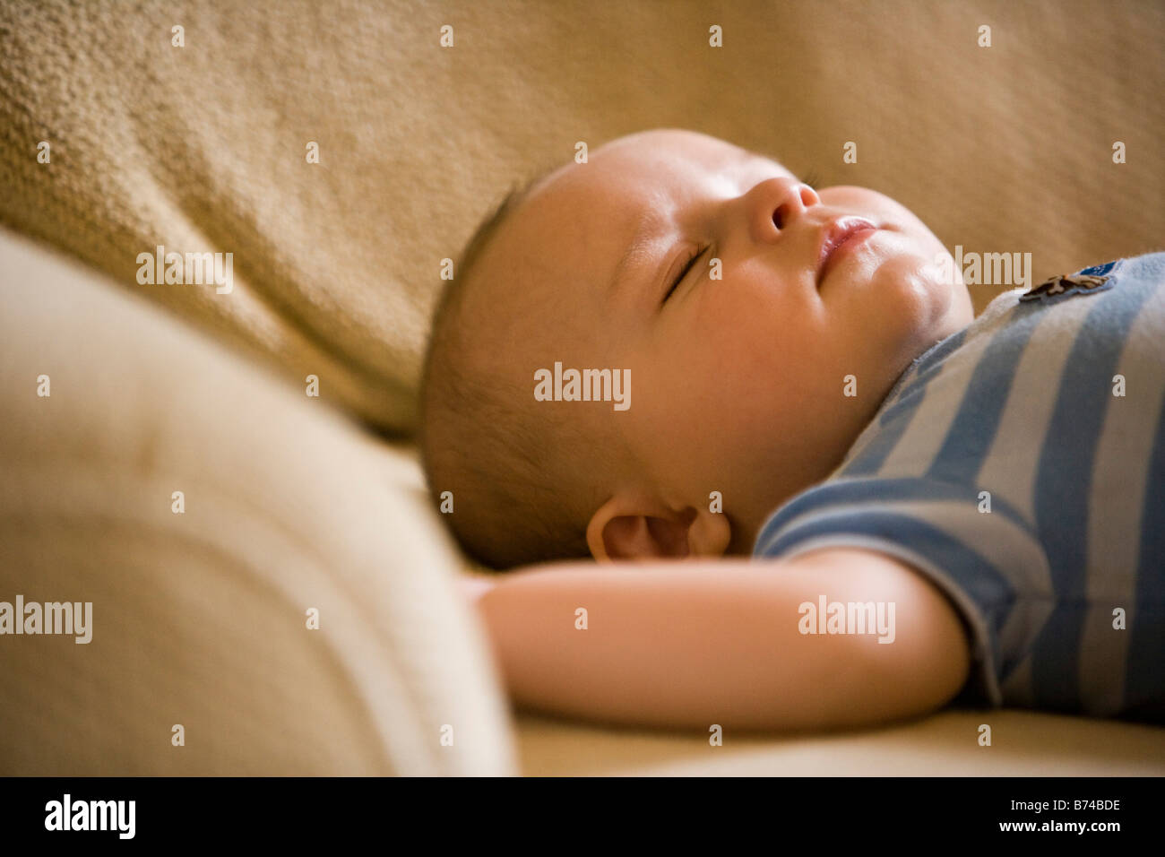 Headshot of baby boy sleeping on sofa Stock Photo - Alamy