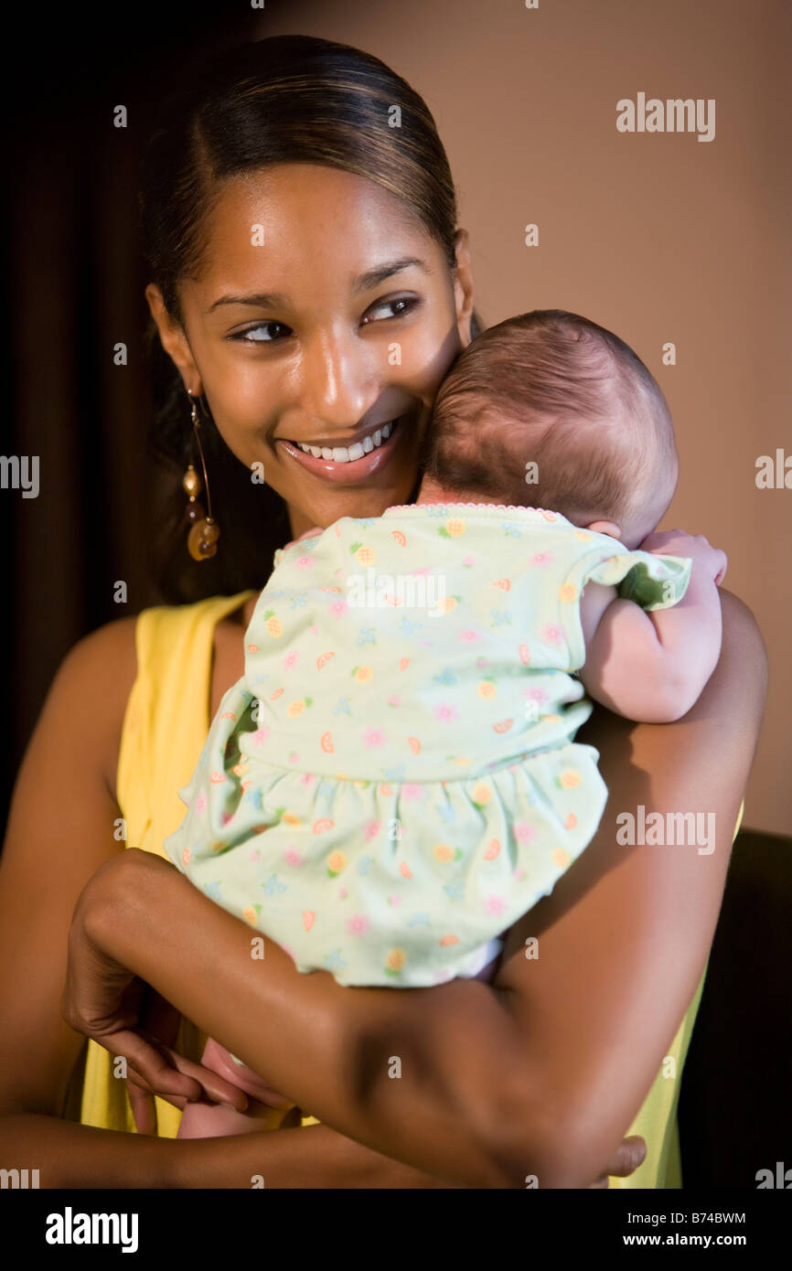 Young African American woman hugging baby Stock Photo - Alamy