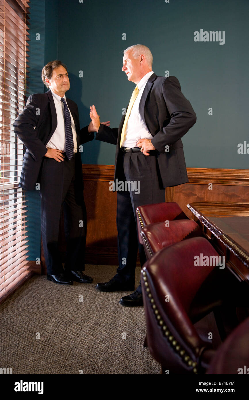 Two corporate executives having serious discussion in conference room ...