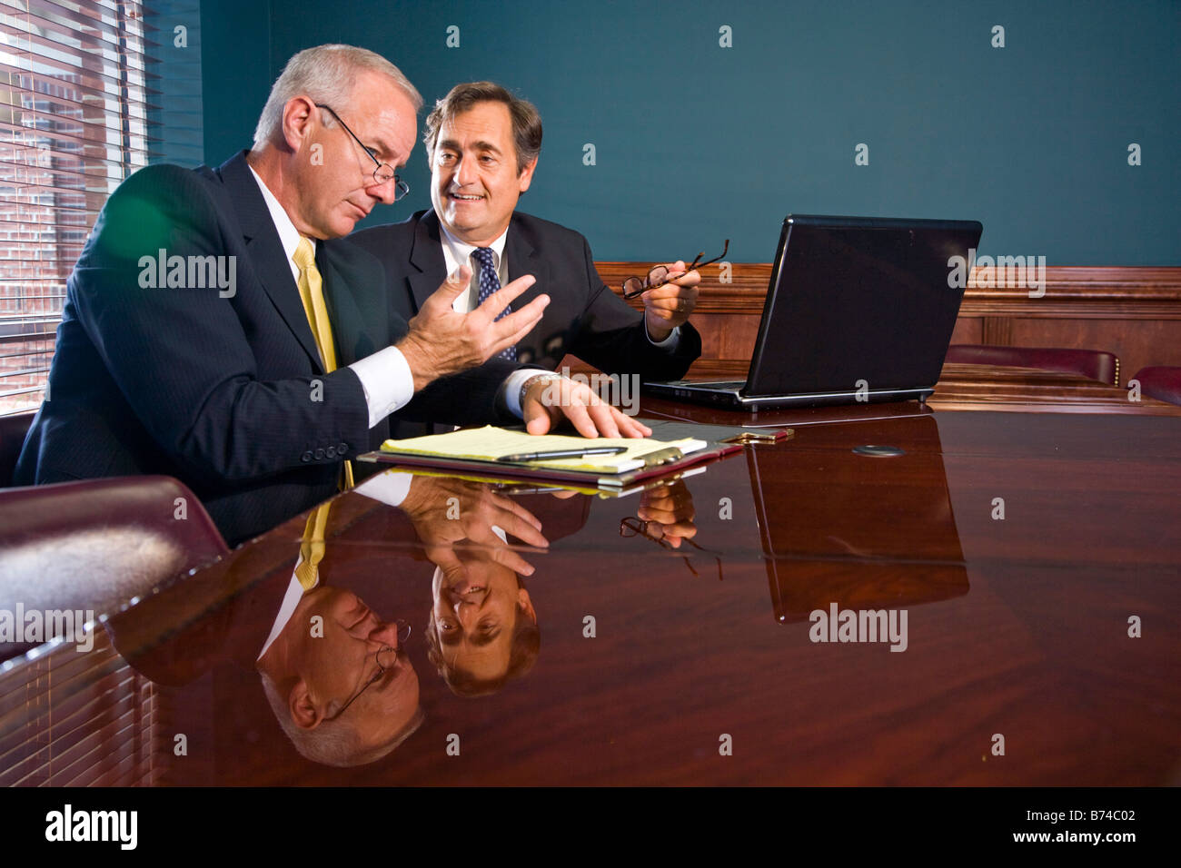 Two corporate executives working together in conference room Stock ...