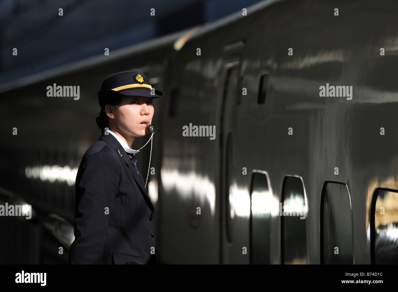 A female train guard on the Shinkansen bullet train at Tokyo Railway ...