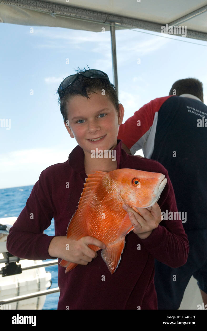 boy with reef fish red emperor Stock Photo - Alamy