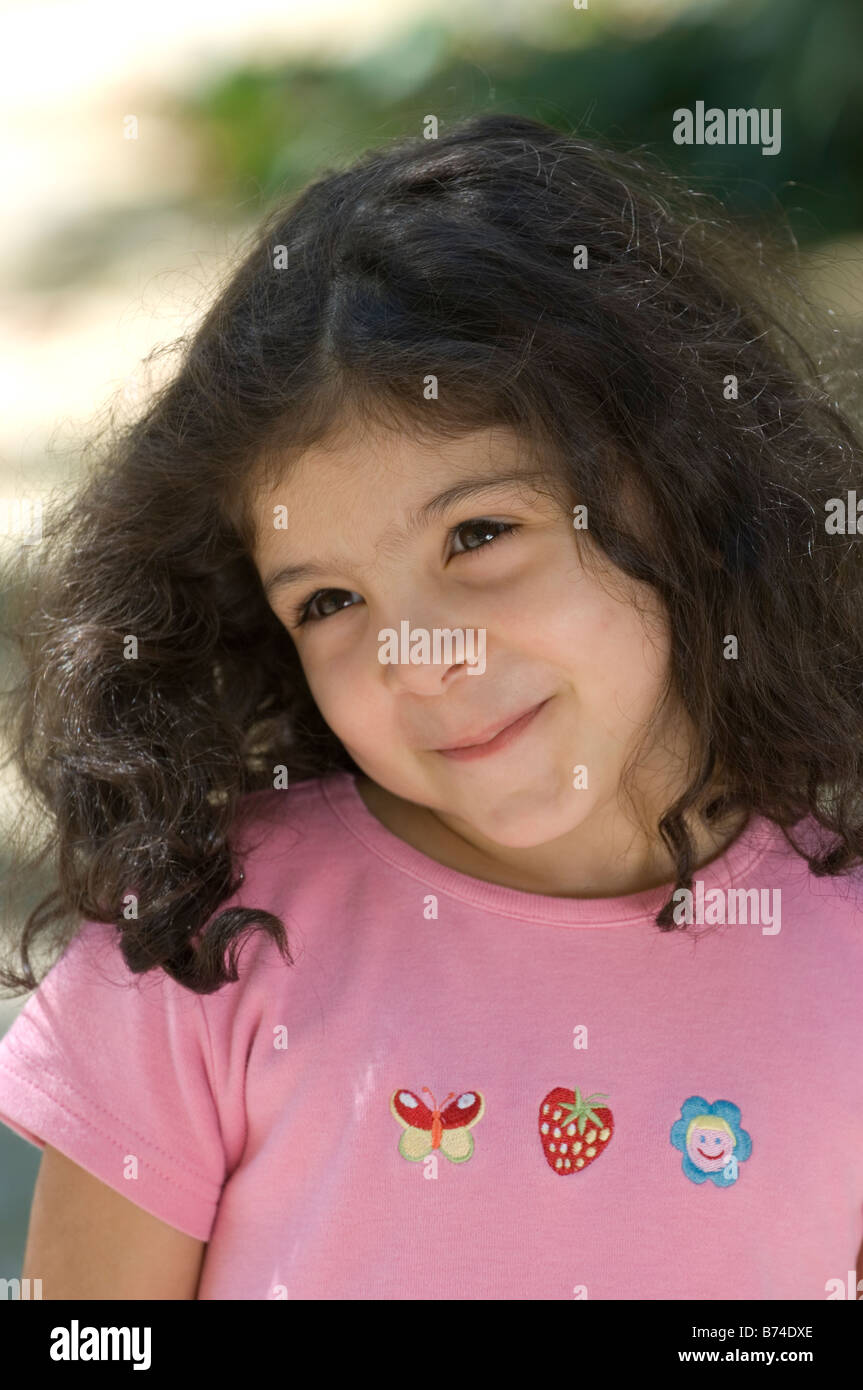 Portrait of a shy little girl smiling Stock Photo - Alamy
