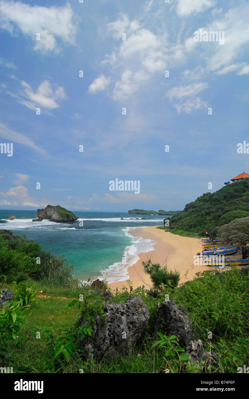 Traditional fishing wooden boat mooring in white sandy beach of Java ...