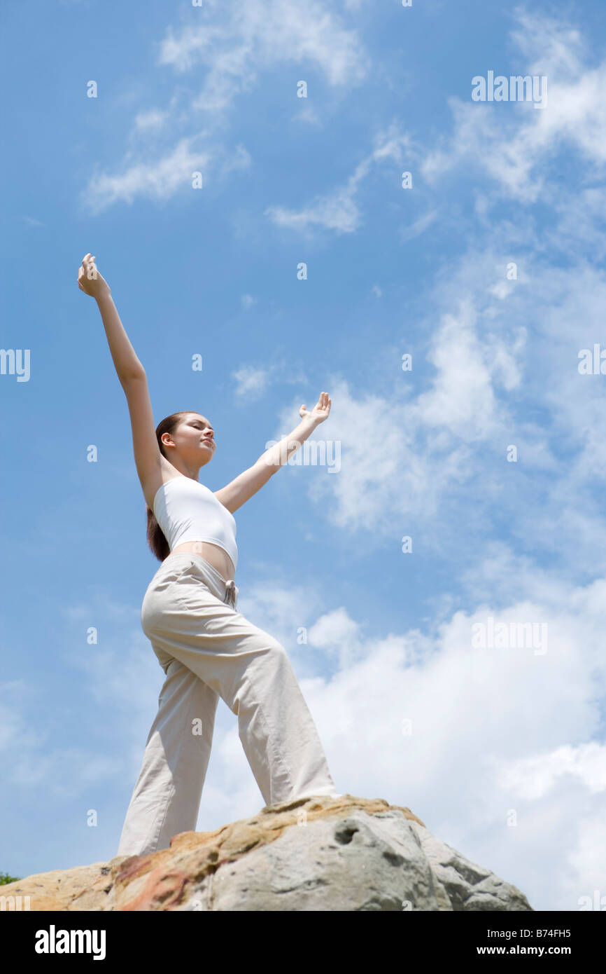 Young woman with arms outstretched Stock Photo - Alamy