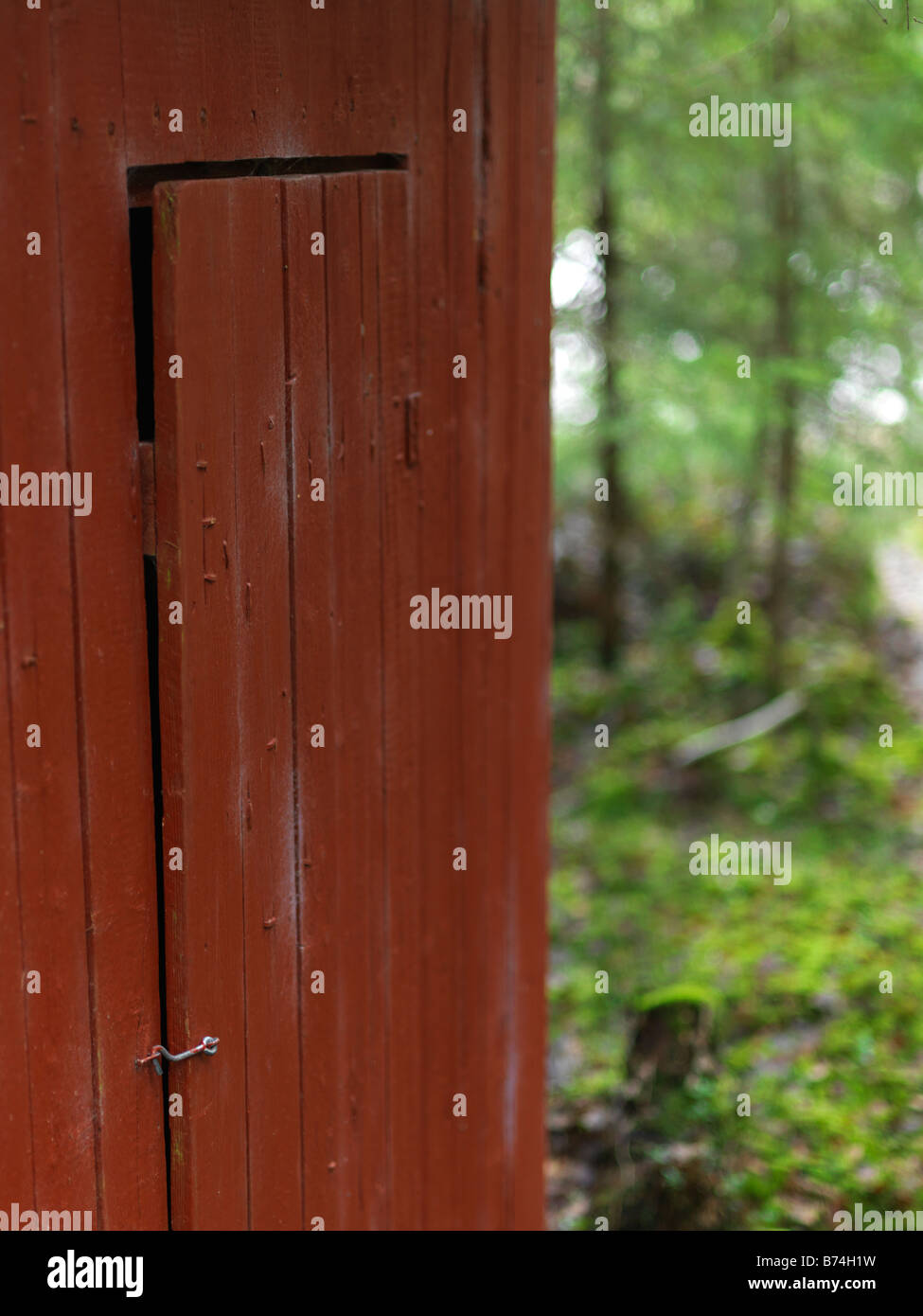 red door outside cabin in the forest of Norway Stock Photo - Alamy
