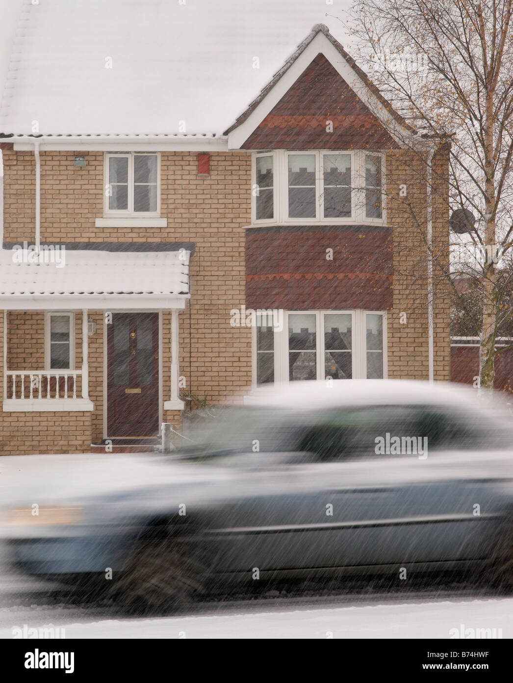 lifestyle picture, Grey car COVERED WITH SNOW moving through snowfall ...