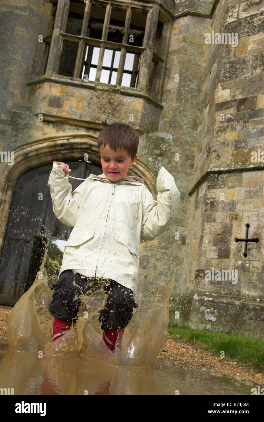 Little Boy Jumping in a Puddle Stock Photo - Alamy