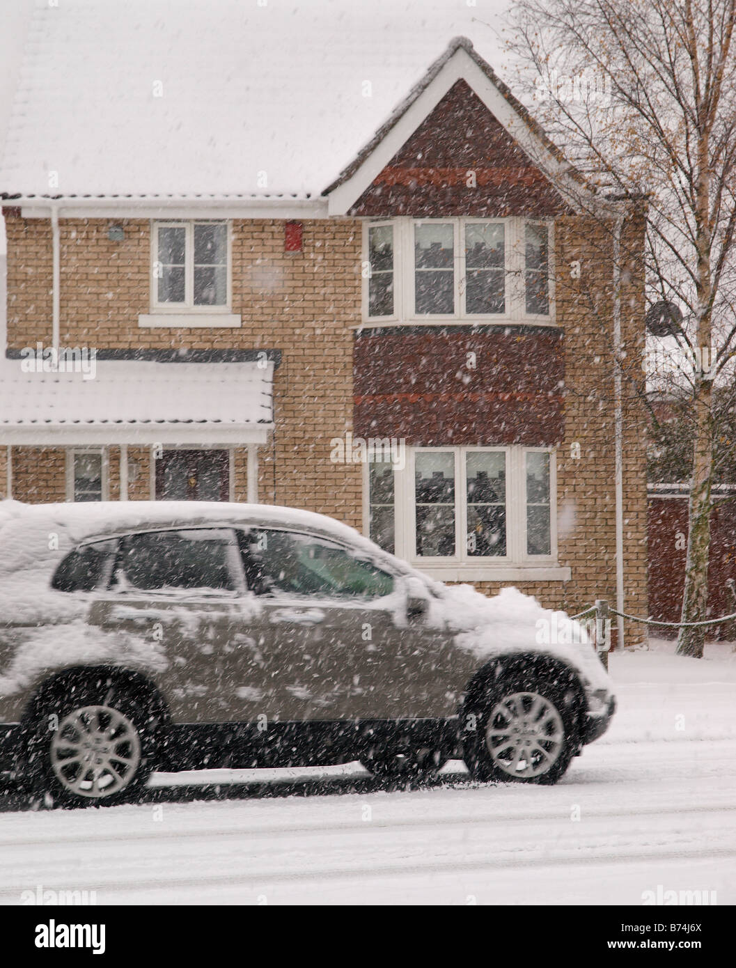lifestyle picture, Grey car COVERED WITH SNOW moving through snowfall ...