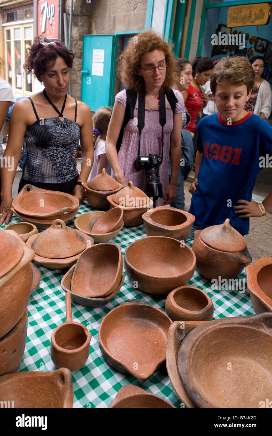 Tourists looking a display of wooden bowls in Lebanon Middle East Stock ...