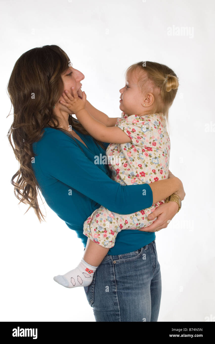 Woman carrying child Stock Photo - Alamy
