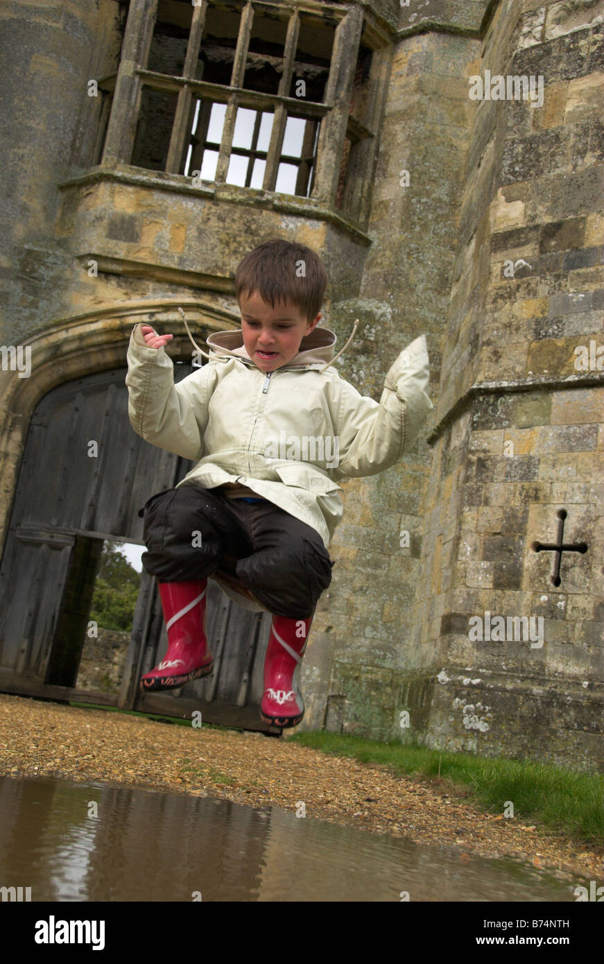 Little Boy Jumping in a Puddle Stock Photo - Alamy