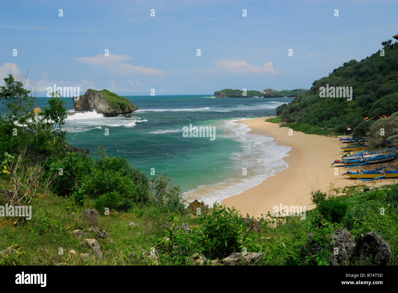 Traditional fishing wooden boat mooring in white sandy beach of Java ...