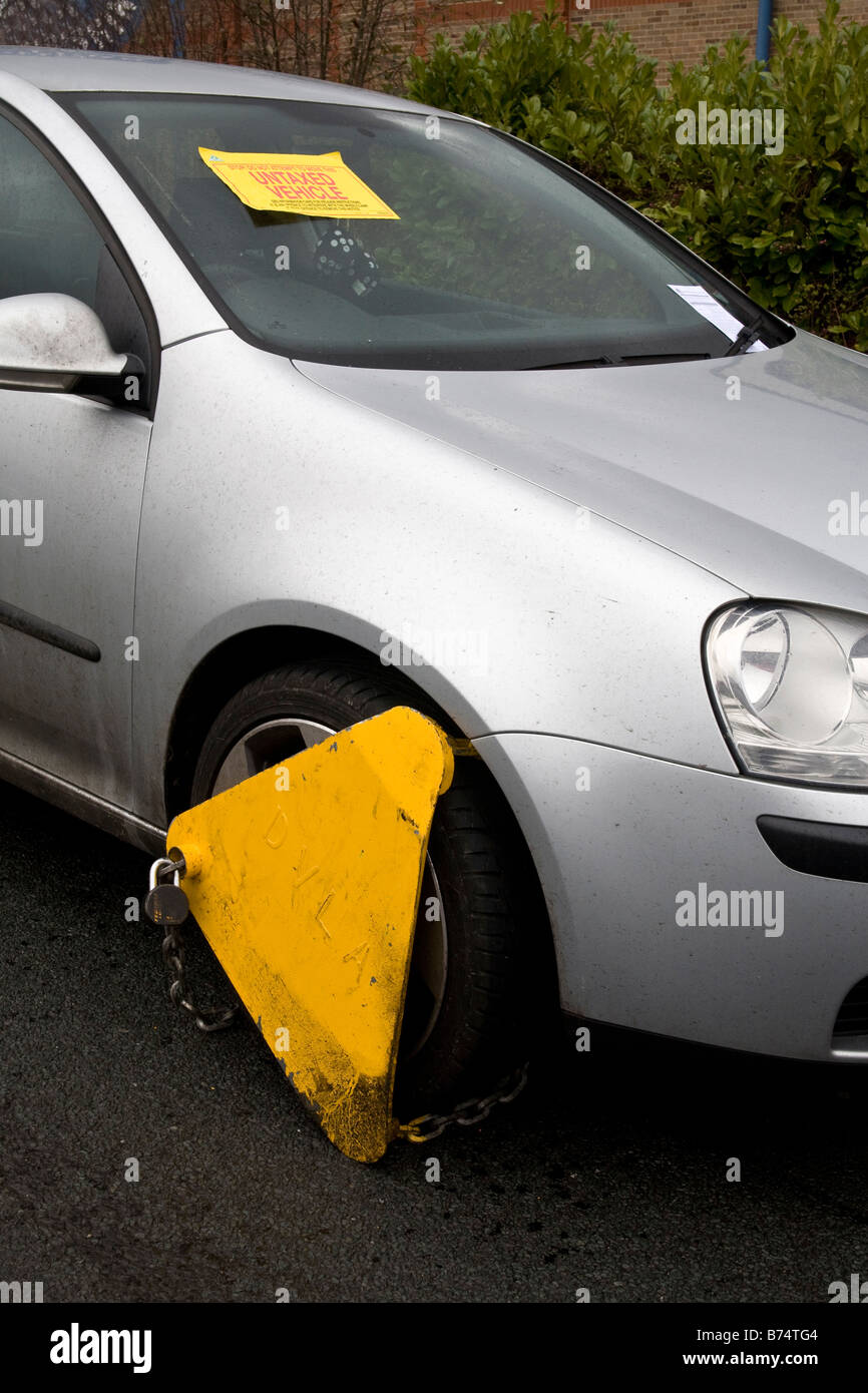 Wheel clamp on untaxed car with statutory notice attached to the ...