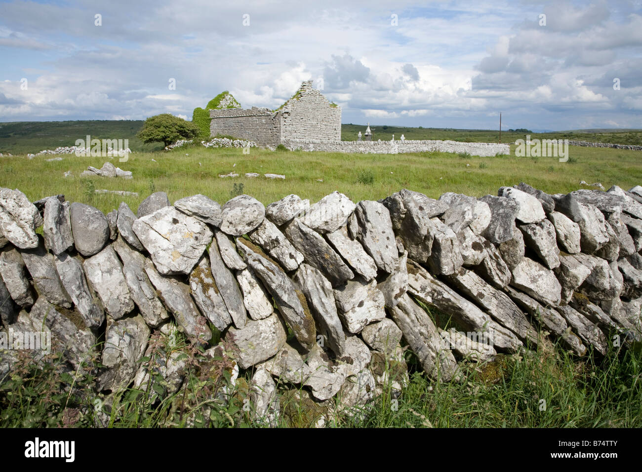 Stone wall in front of building in the Burren Stock Photo - Alamy