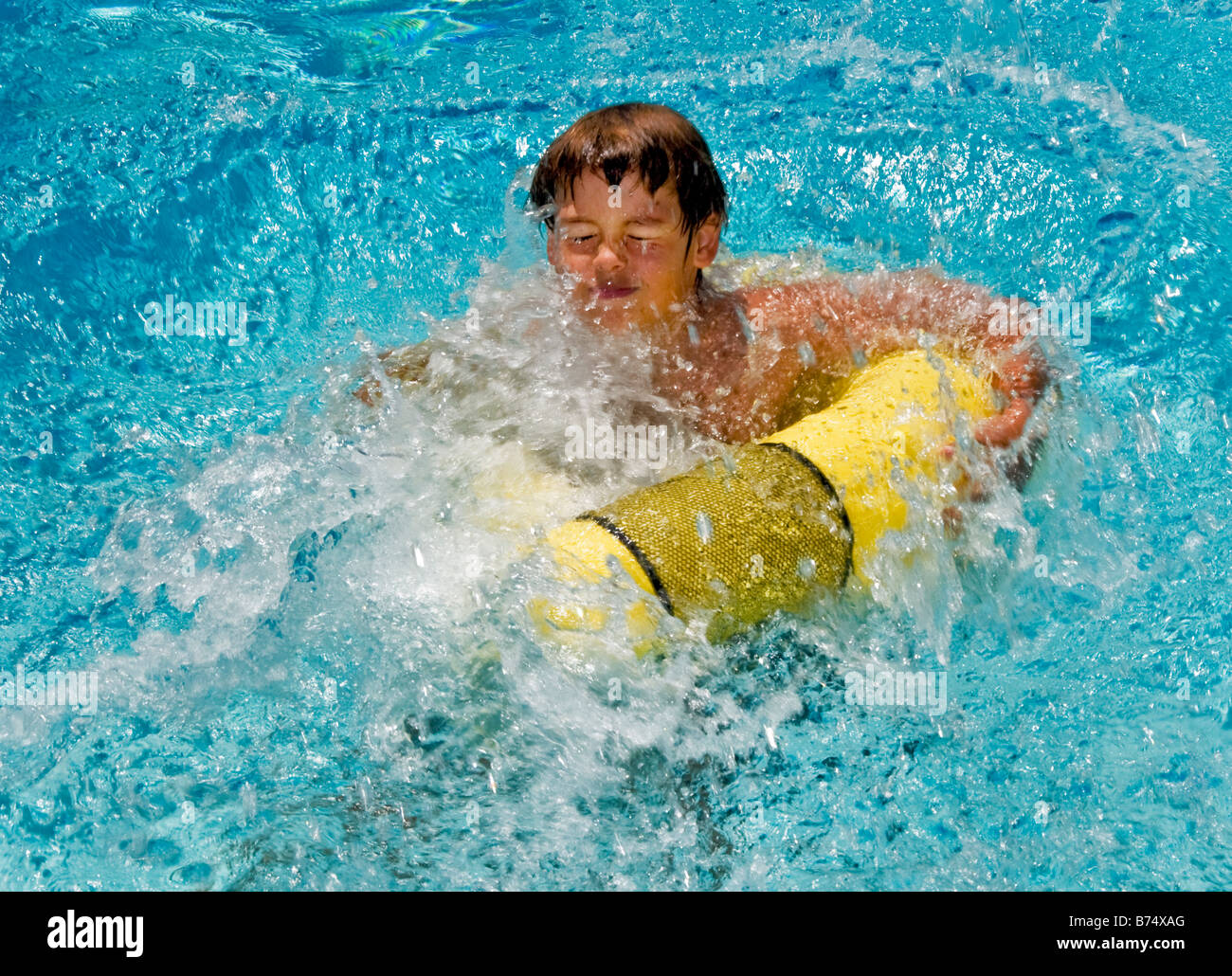 Grimacing A 10 Year Old Boy Splashes Into A Swimming Pool In Laguna Grimacing A 10 Year Old Boy Splashes Into A Swimming Pool In Laguna