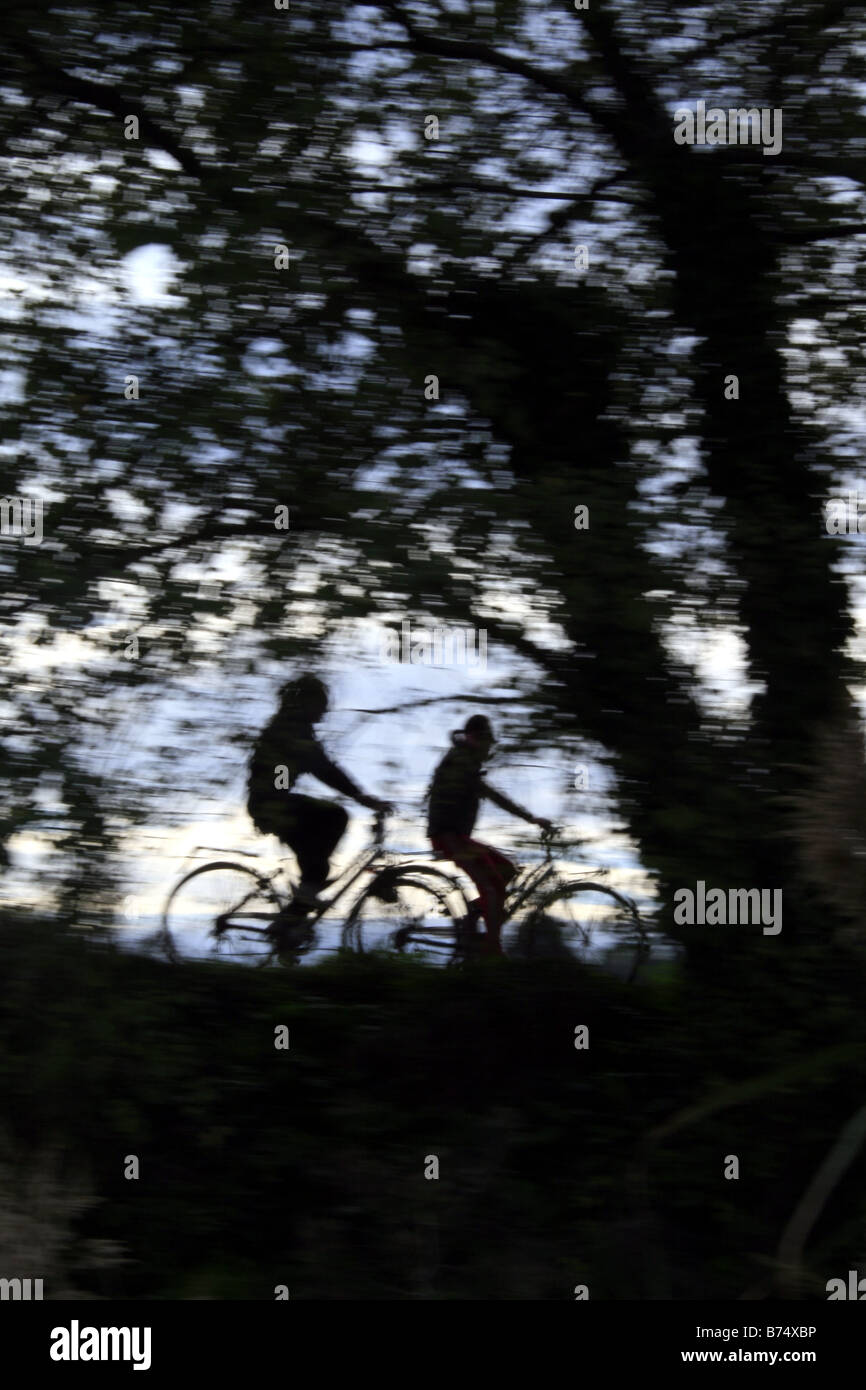 two people riding fast bikes on rural lane countryside Stock Photo - Alamy