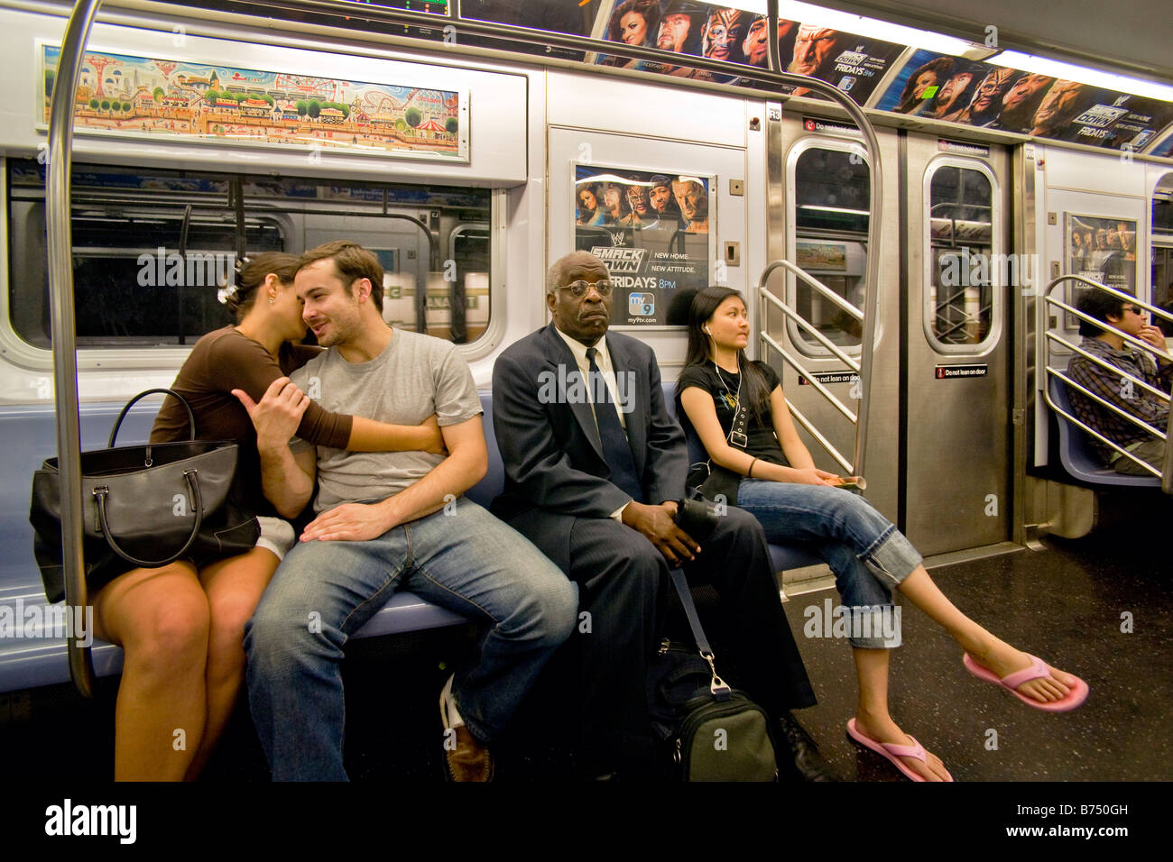 Oblivious of their surroundings a couple is openly affectionate in a ...