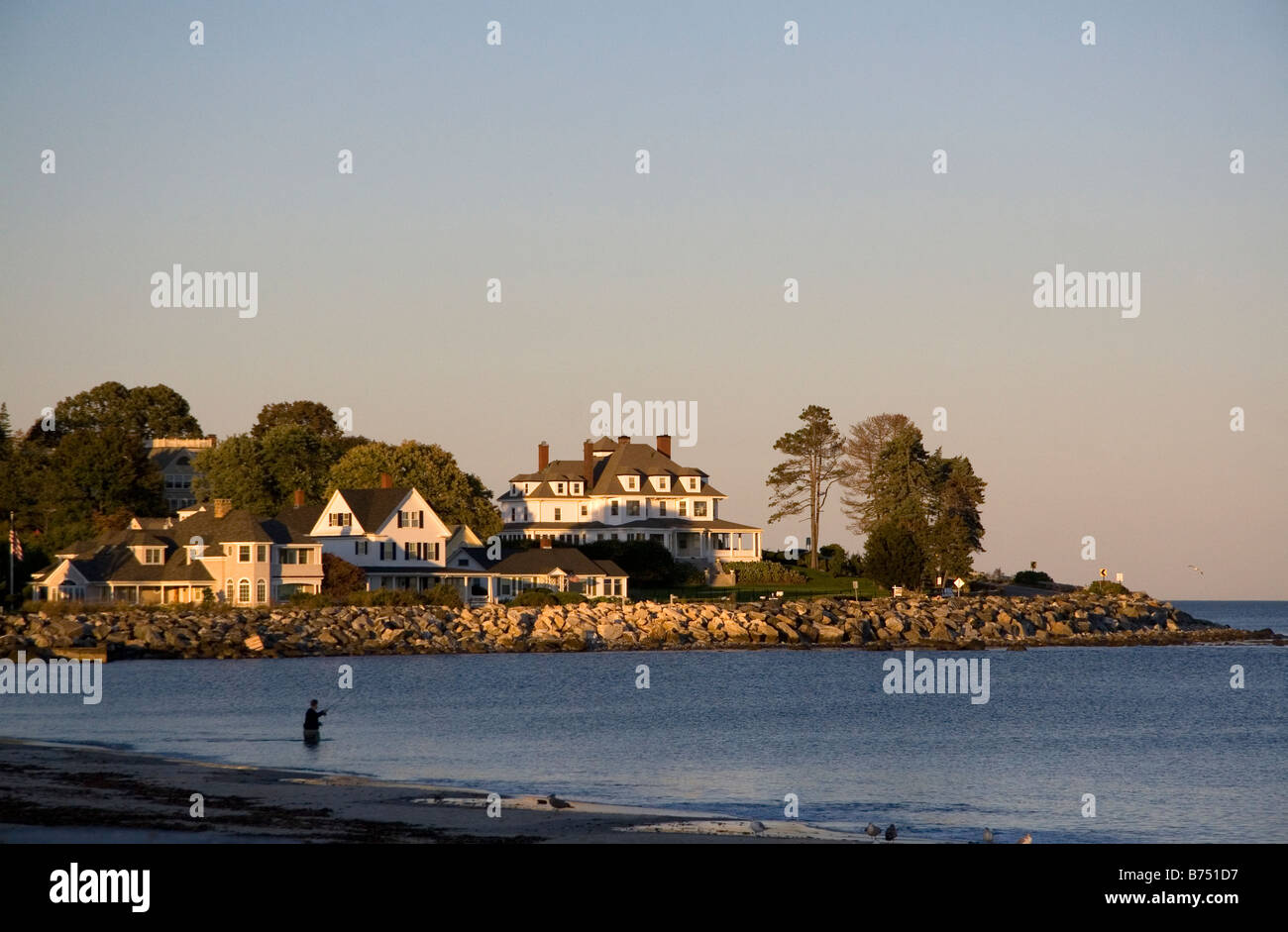 Waterfront home and man fishing at the village of Hampton Beach New ...