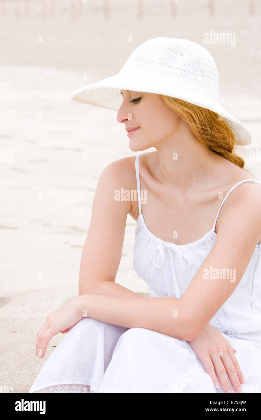 Young woman wearing sun hat on beach Stock Photo - Alamy