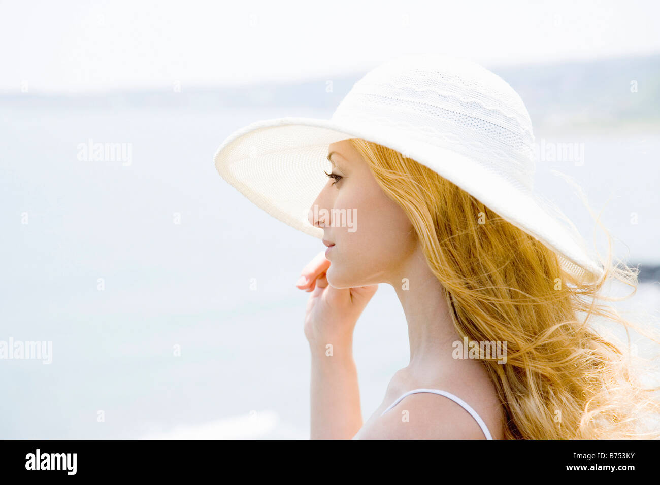Woman wearing sunhat on beach hi-res stock photography and images - Alamy