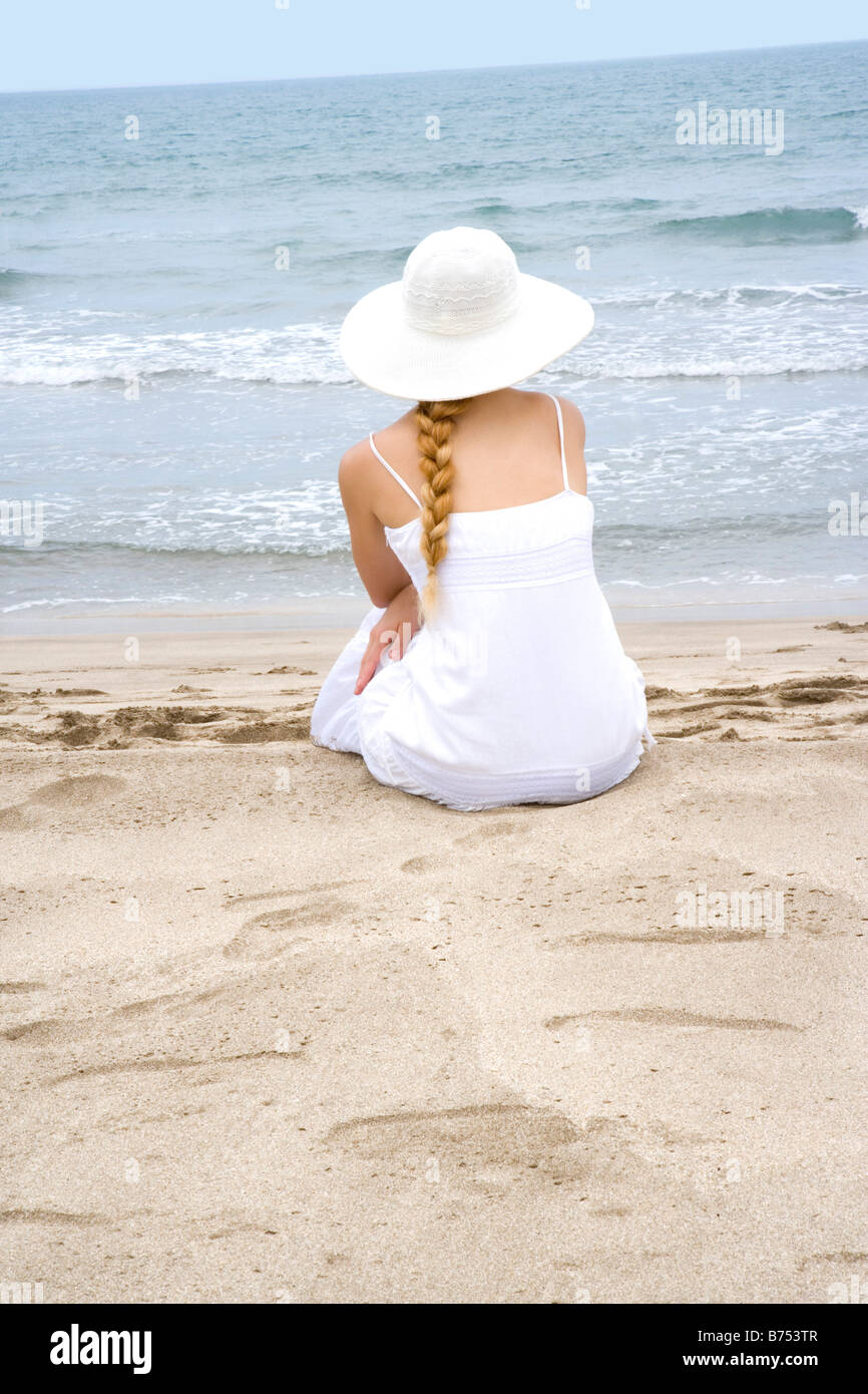 Young woman wearing sun hat on beach rear view Stock Photo - Alamy