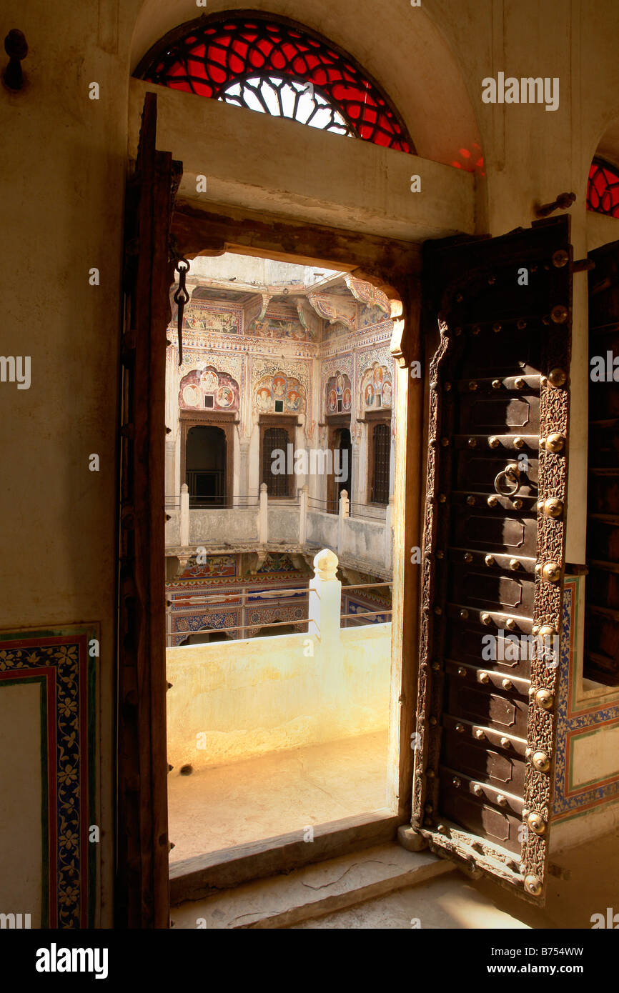 old wooden door looking out into the courtyard of the anandilal poddar ...