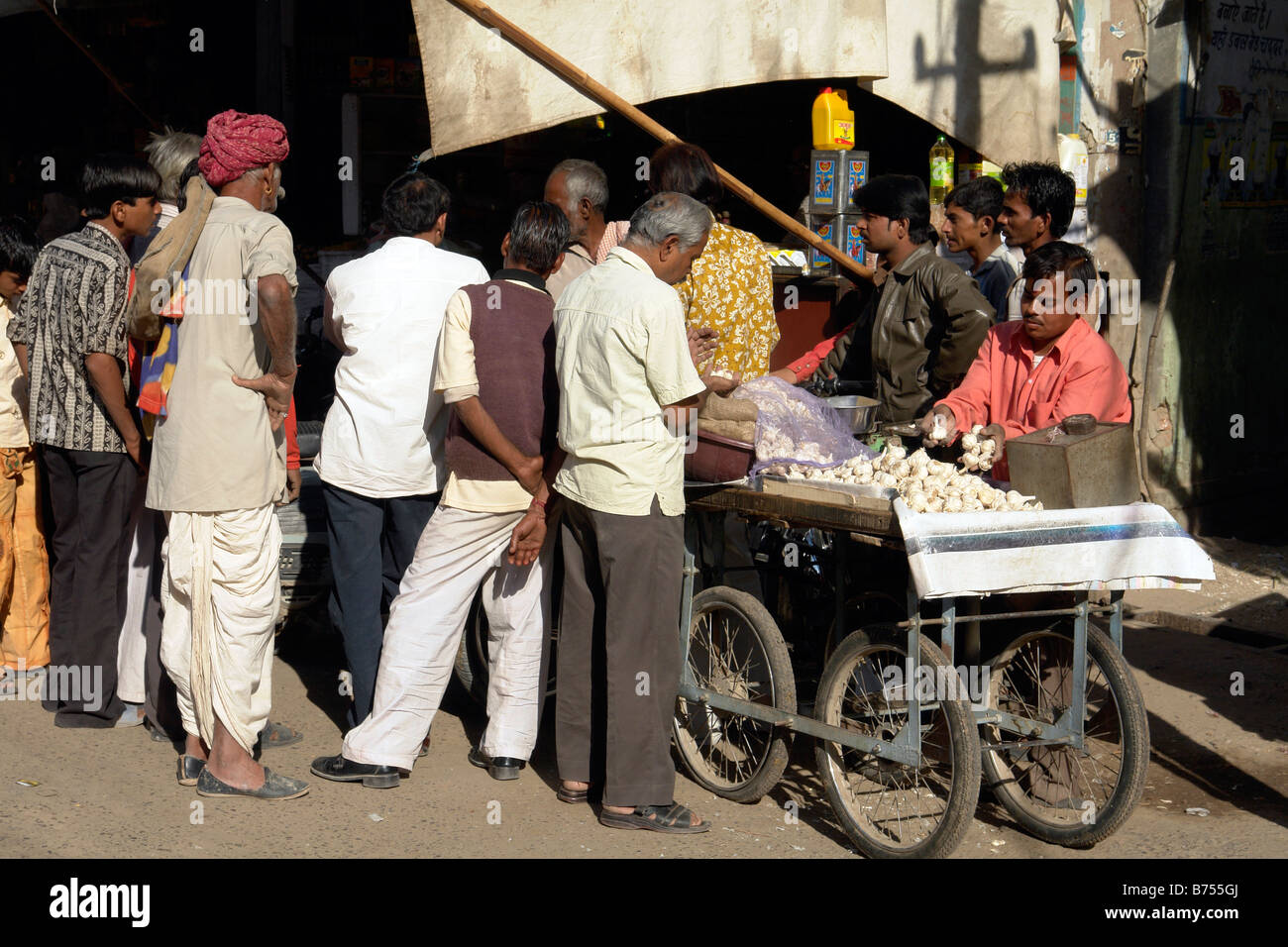 indian shoppers at a market stall in the back streets of the old town ...