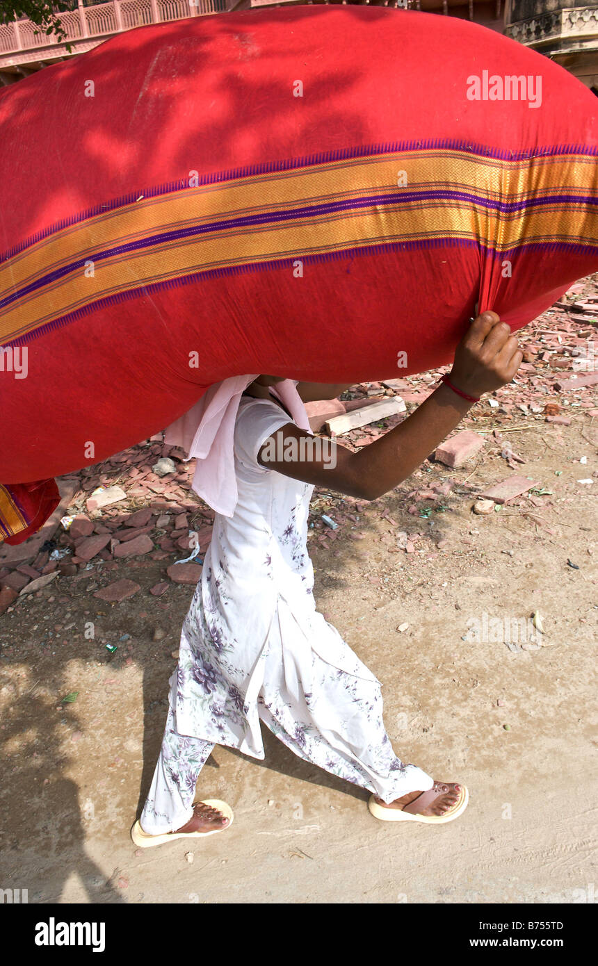 India Vrindavan a woman carrying a heavy sack Stock Photo - Alamy