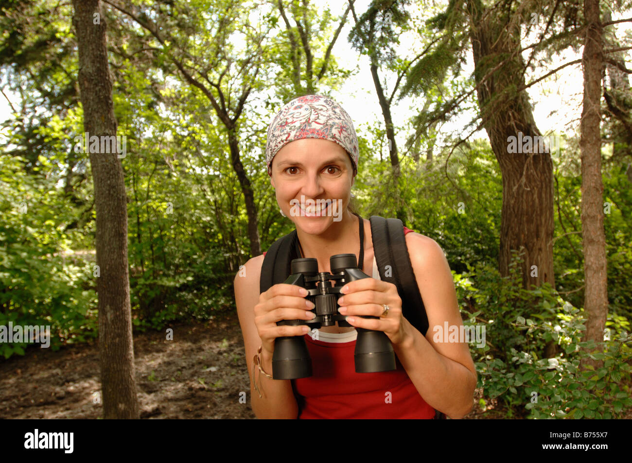Woman in woods with binoculars, Regina, Saskatchewan Stock Photo - Alamy