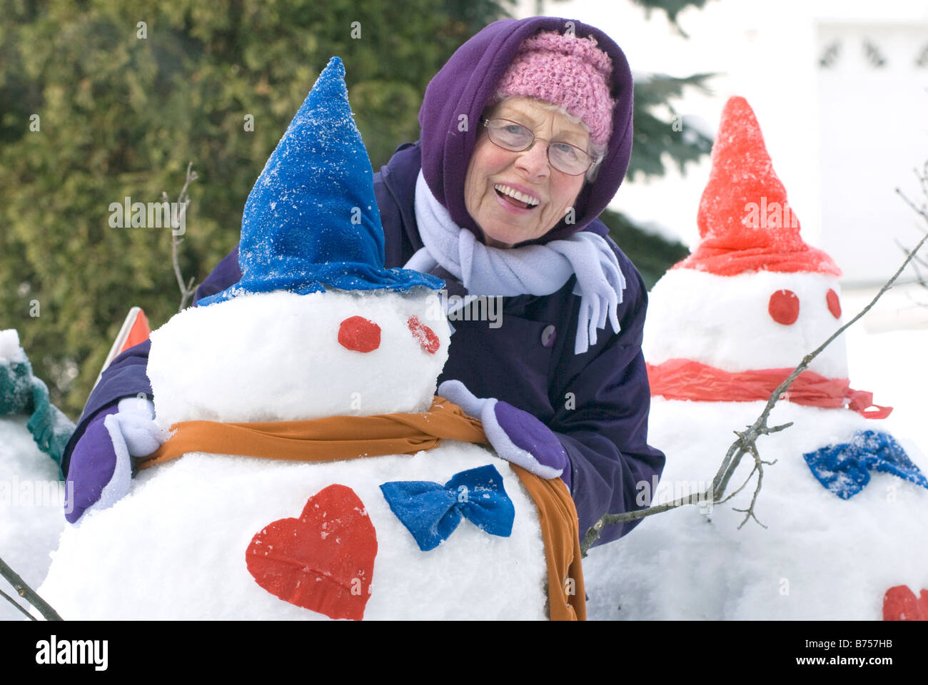 Senior woman showing off snowman that she made, Winnipeg, Canada Stock ...