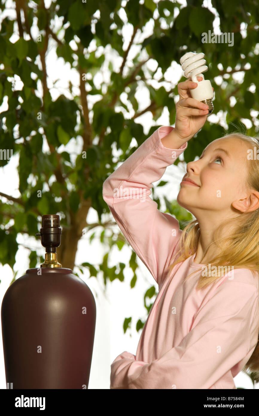 Young girl with an energy efficient light bulb, Toronto, Canada Stock ...