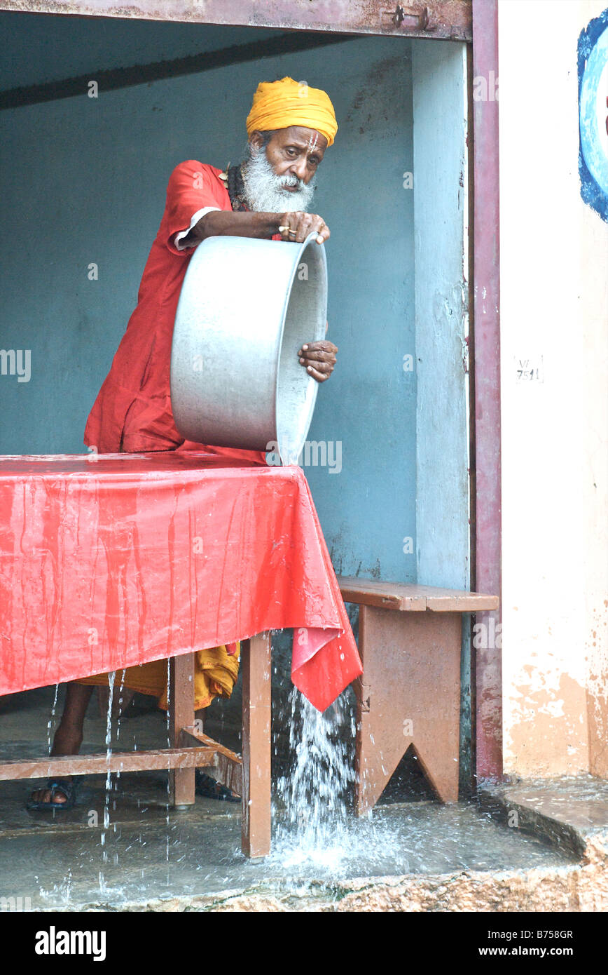 India Vrindavan a local man cleaning his shop Stock Photo - Alamy