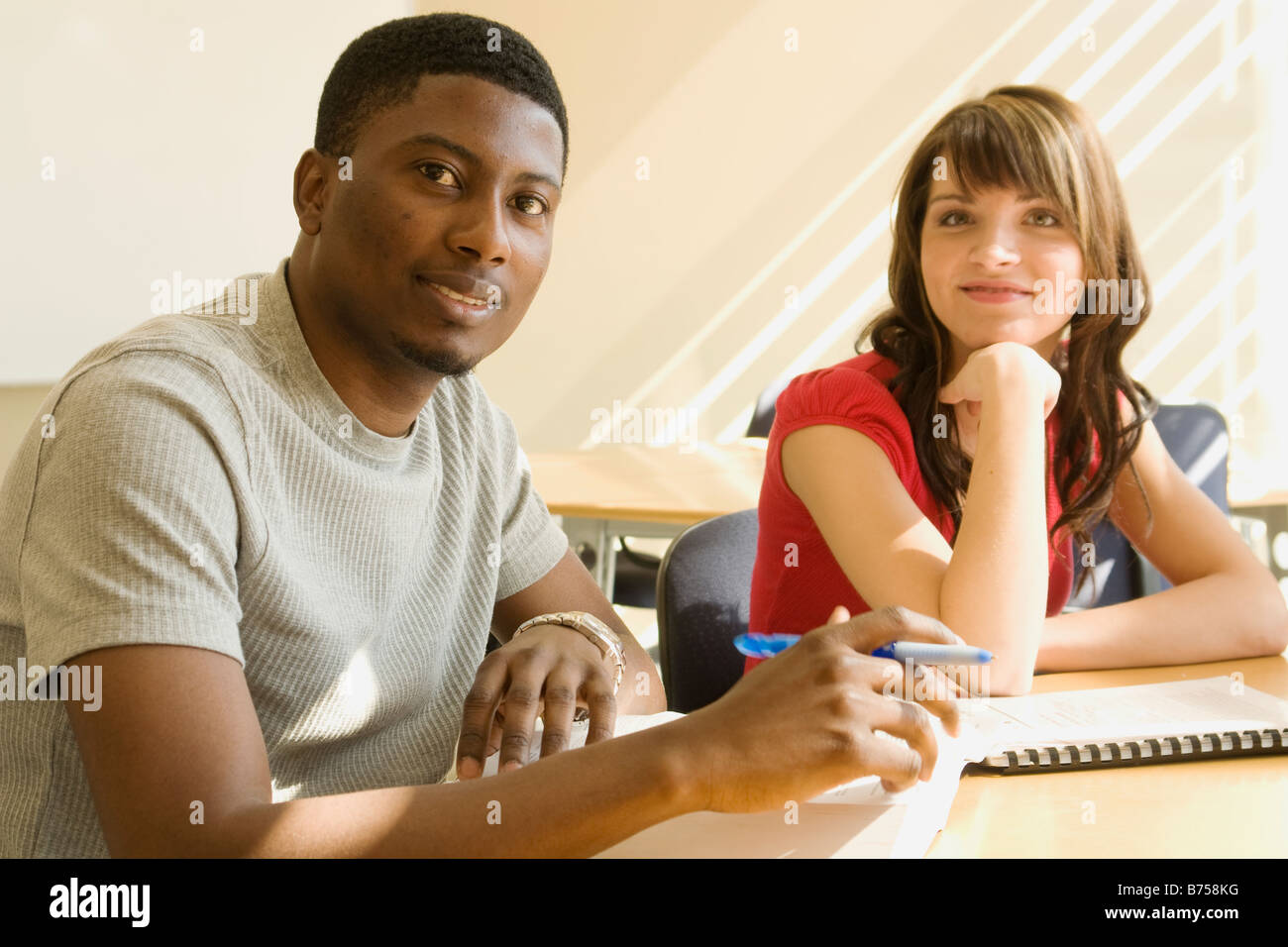 Portrait of 2 students seated at table, Winnipeg, Canada Stock Photo ...