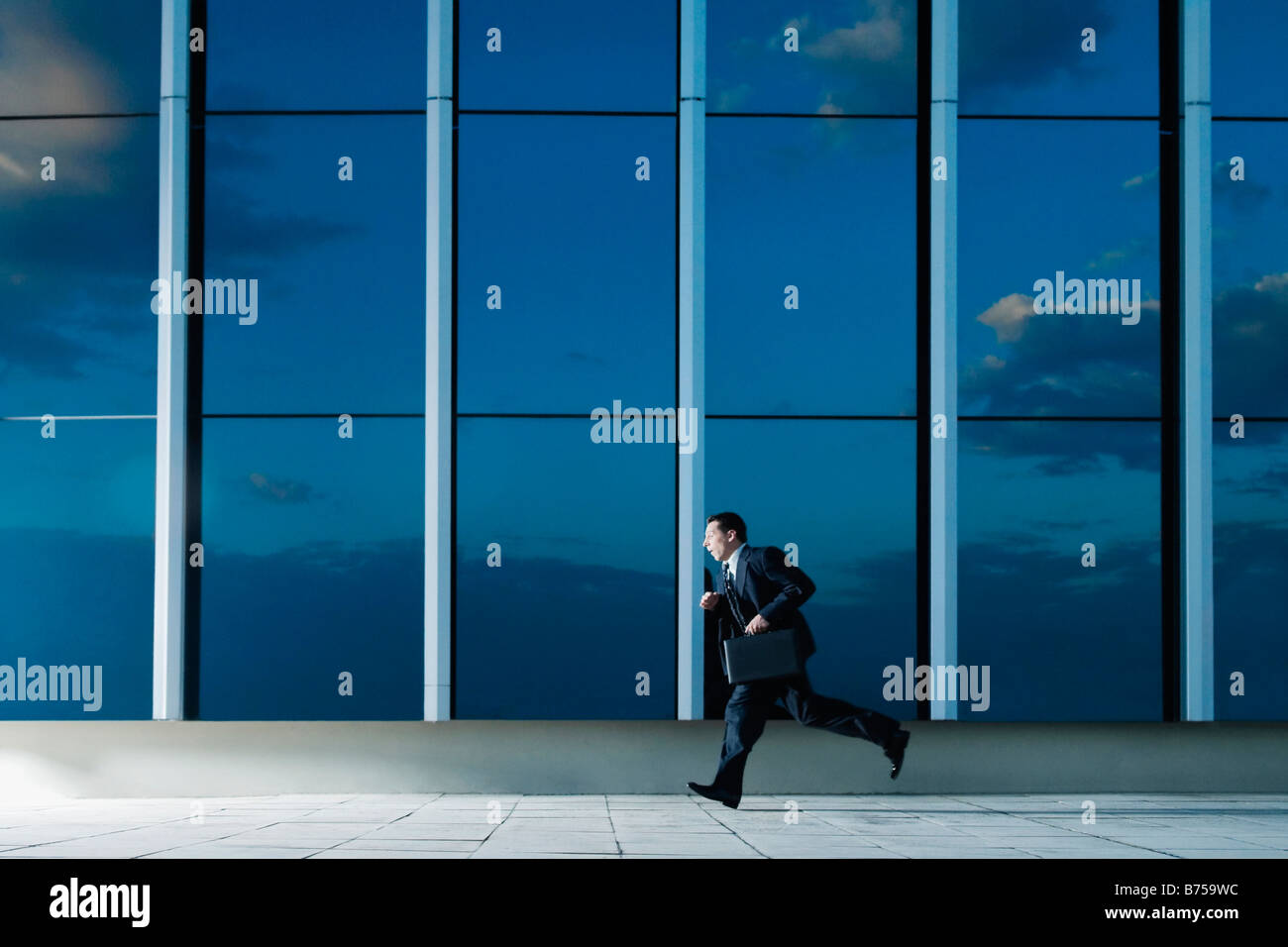 Side profile of a businessman running with a briefcase hi-res stock ...