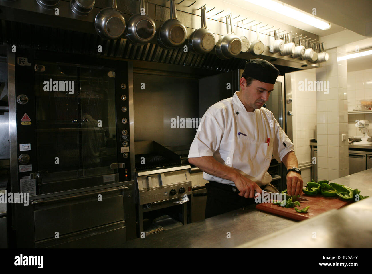 a chef cooking in a kitchen Stock Photo - Alamy