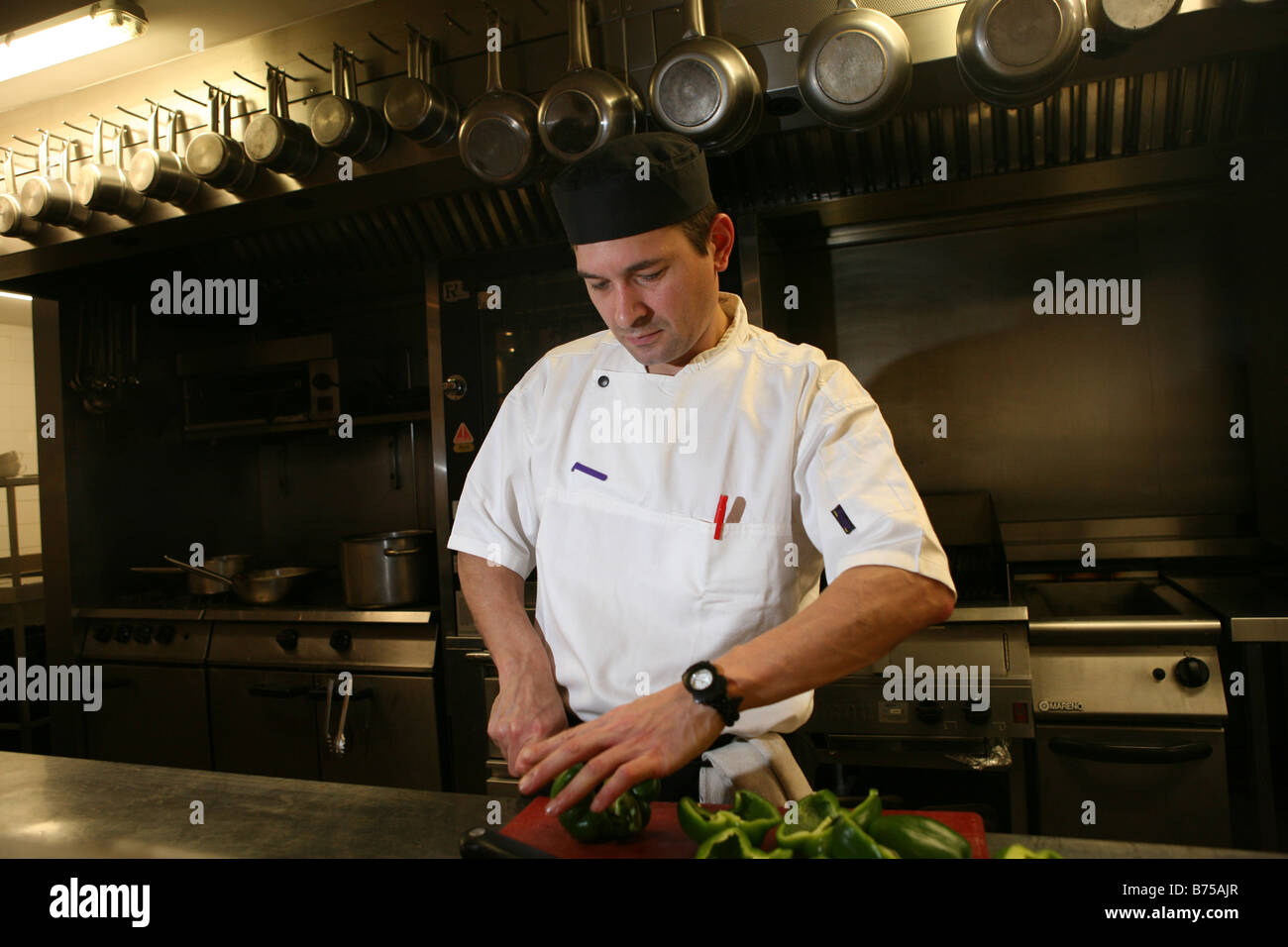 a chef cooking in a kitchen Stock Photo - Alamy