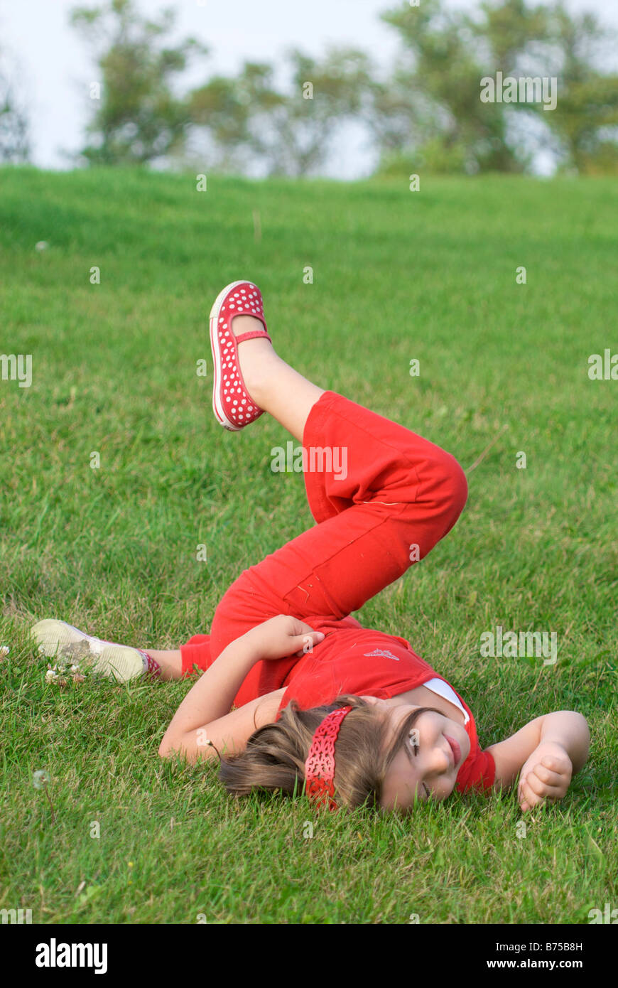 Child rolling in grass hi-res stock photography and images - Alamy