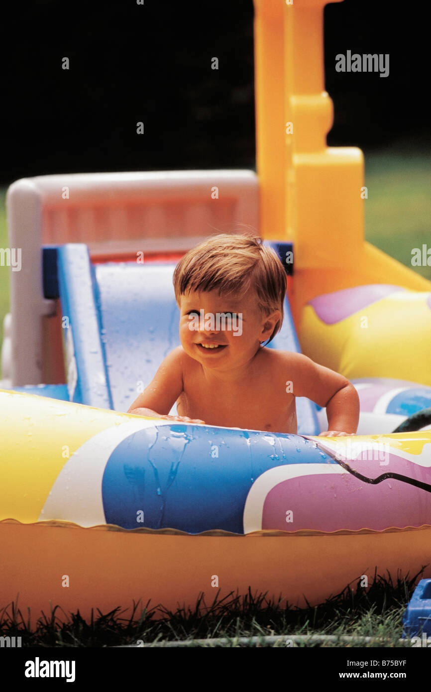 Portrait of a boy bathing in a wading pool Stock Photo - Alamy