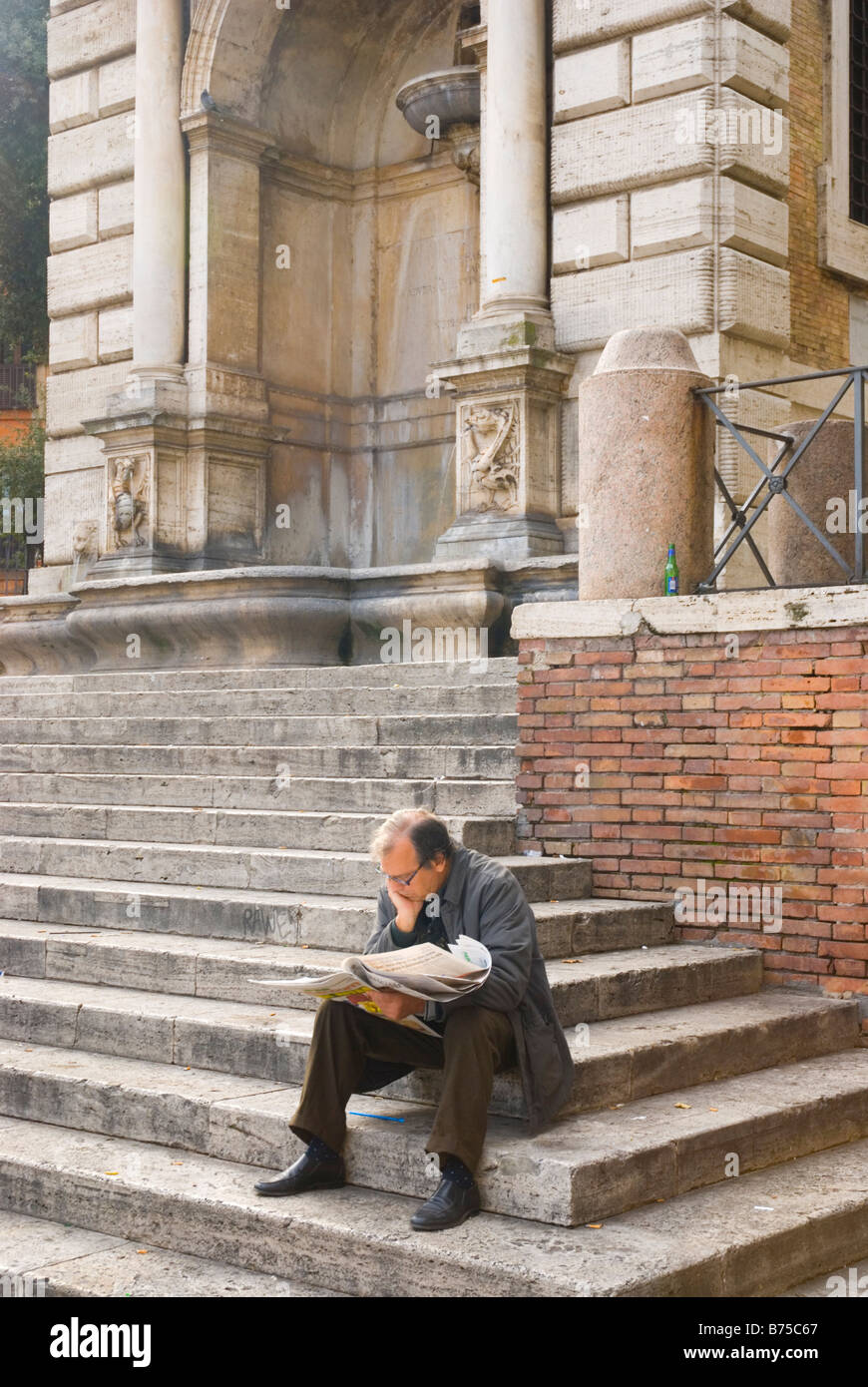 Man reading newspaper at Piazza Trilussa in Trastevere district of Rome ...
