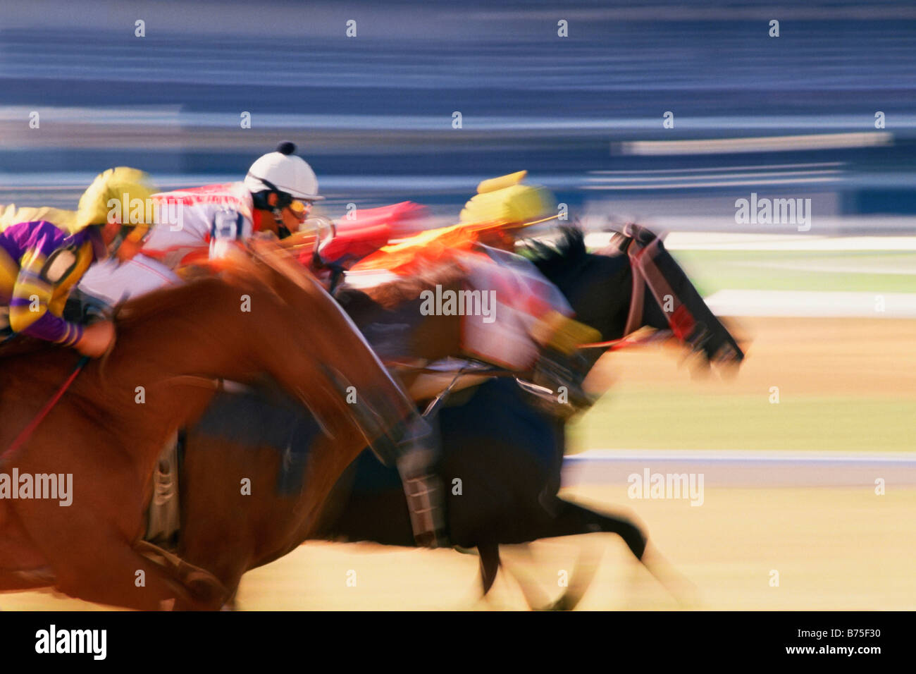 Three horses racing at a race track hi-res stock photography and images ...