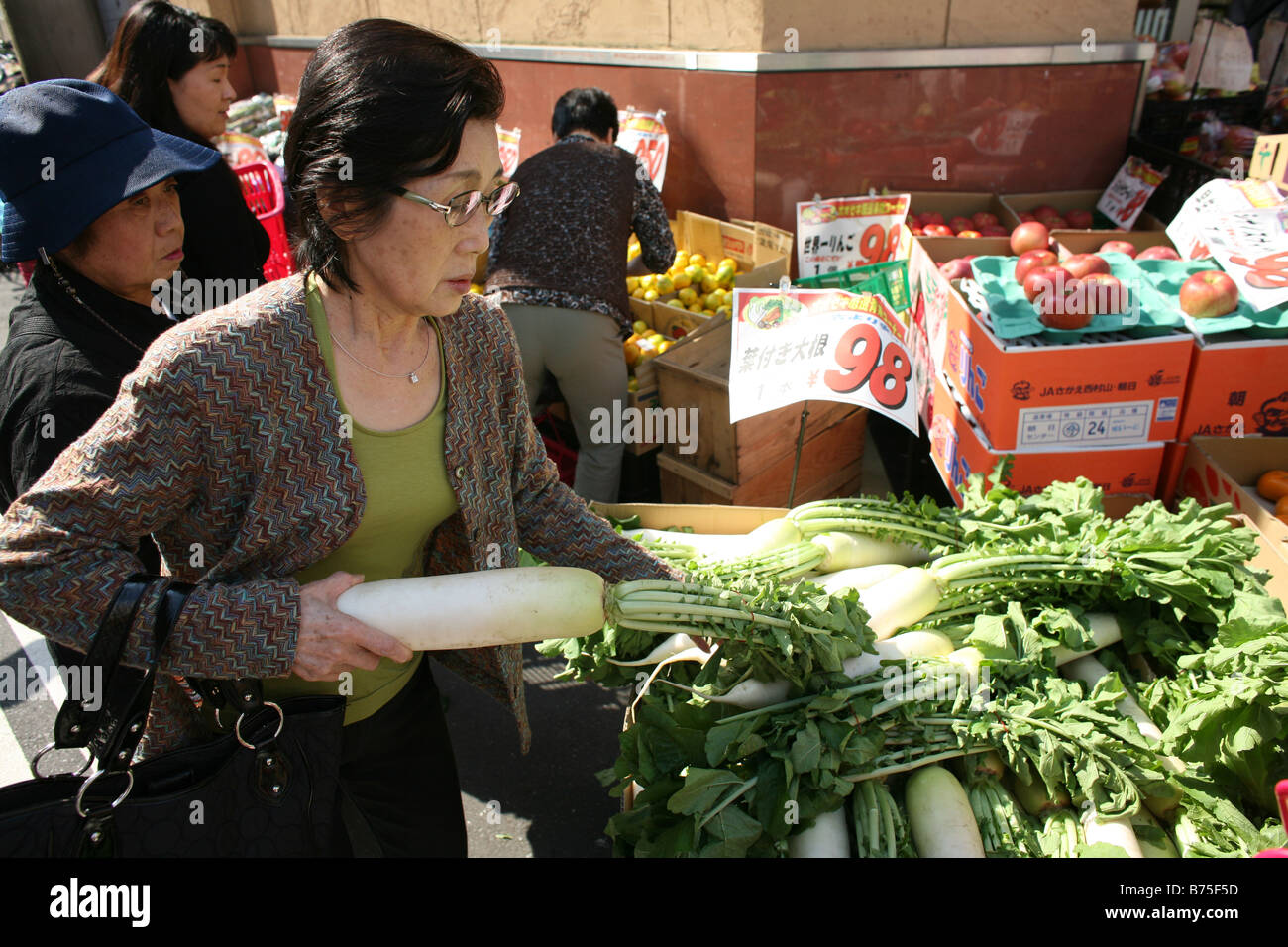 Old woman buys vegetables at the Tokyo vegetable market Stock Photo - Alamy