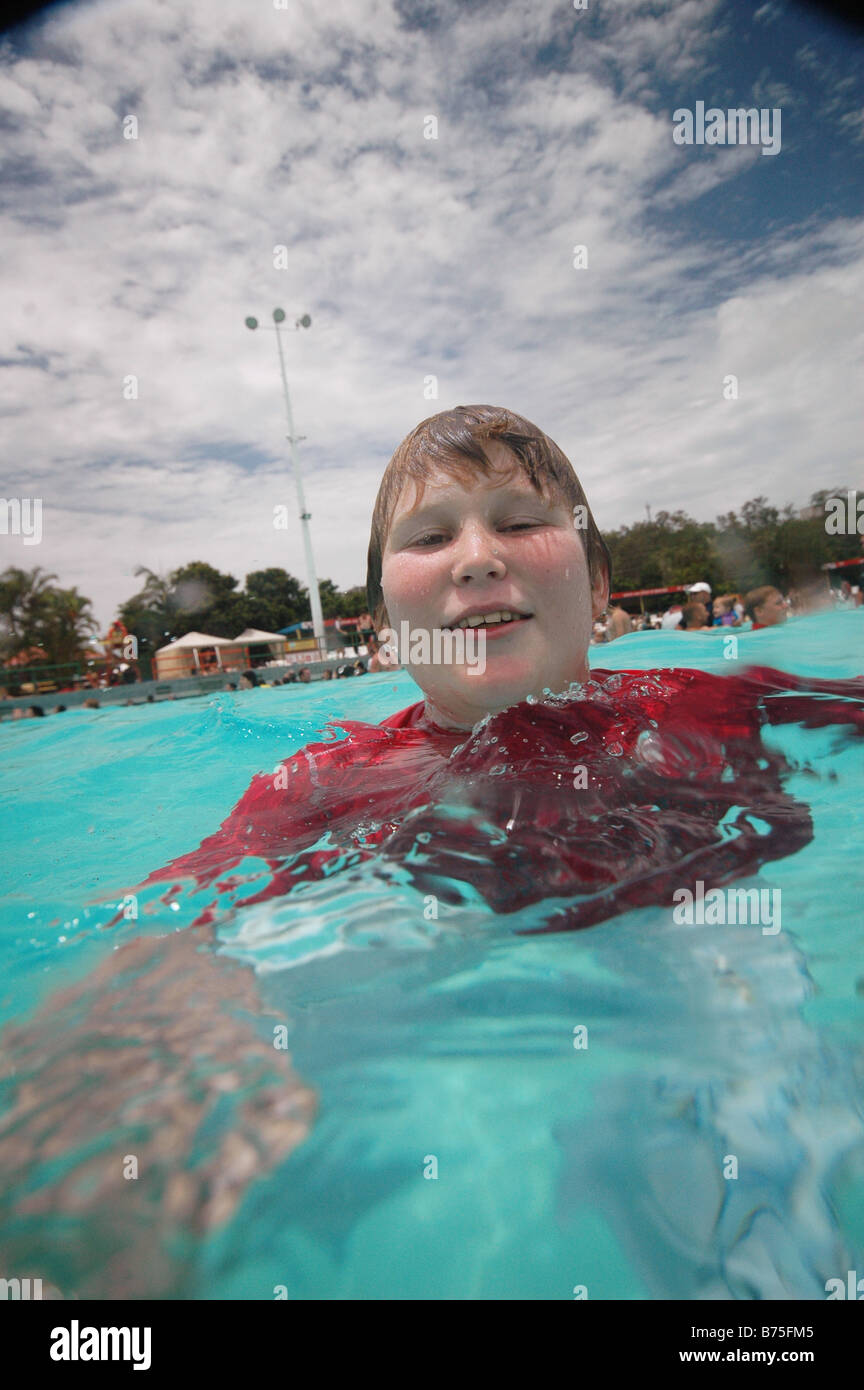 young boy floating in swimming pool Stock Photo - Alamy