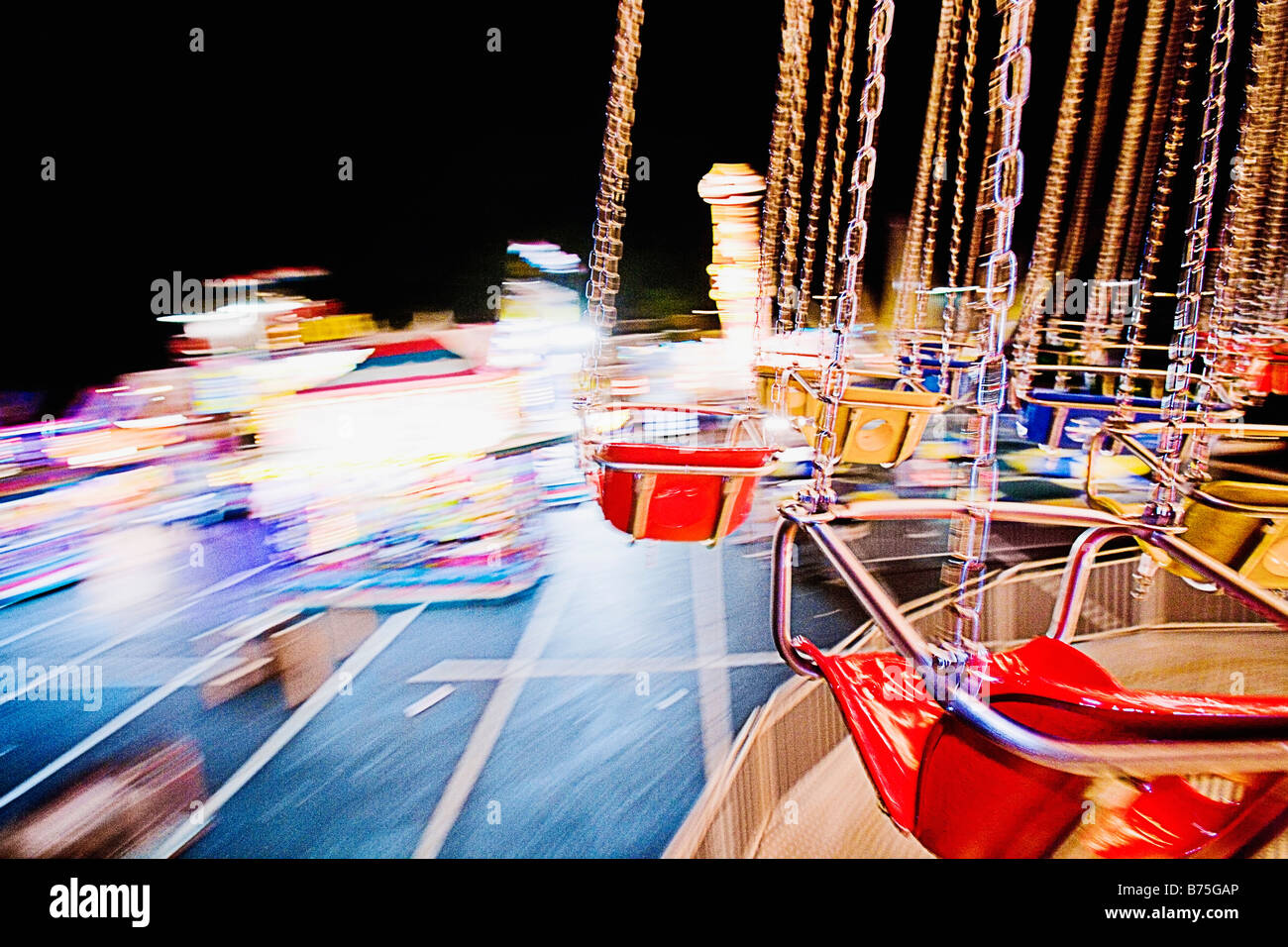 Spinning swings at amusement park hi-res stock photography and images - Alamy