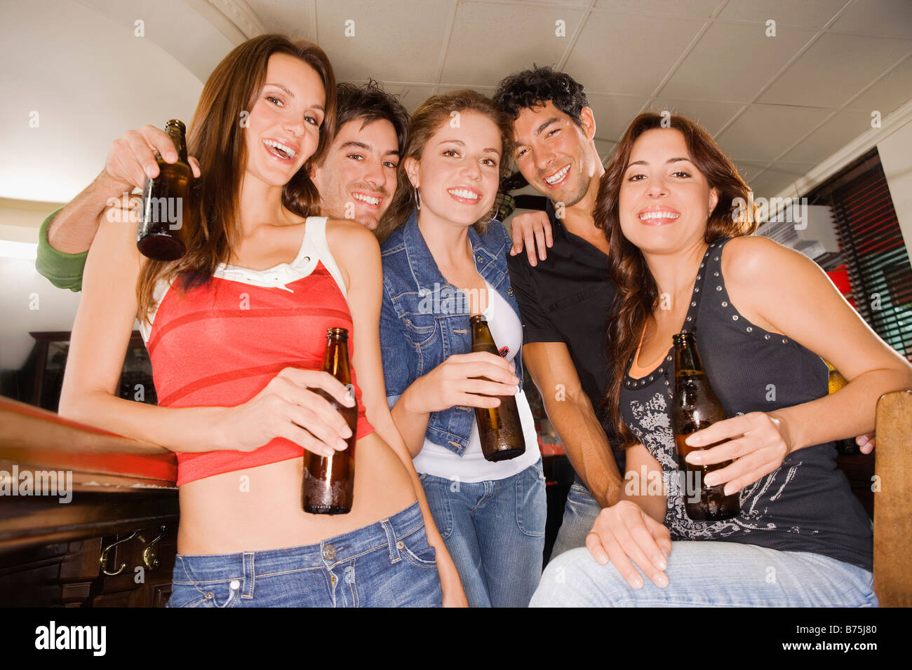 Portrait of five friends smiling at a bar counter Stock Photo - Alamy